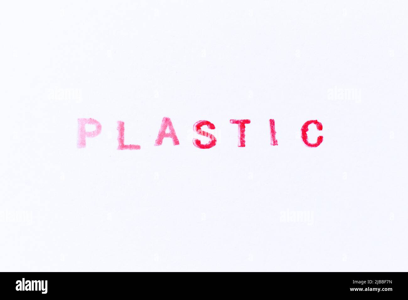 Red color ink rubber stamp in word plastic on white paper background ...