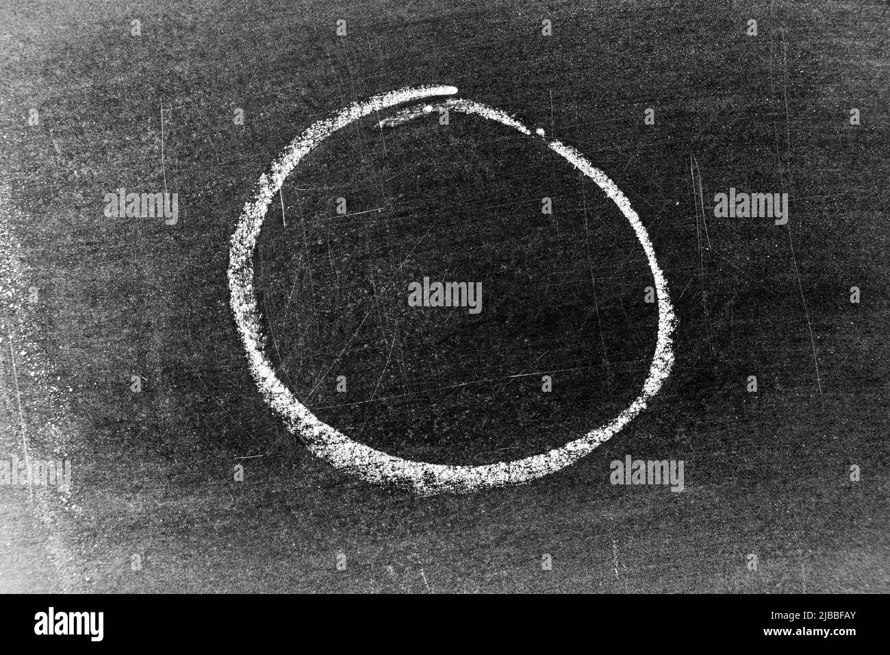 White chalk hand drawing as circle or round shape on blackboard or ...