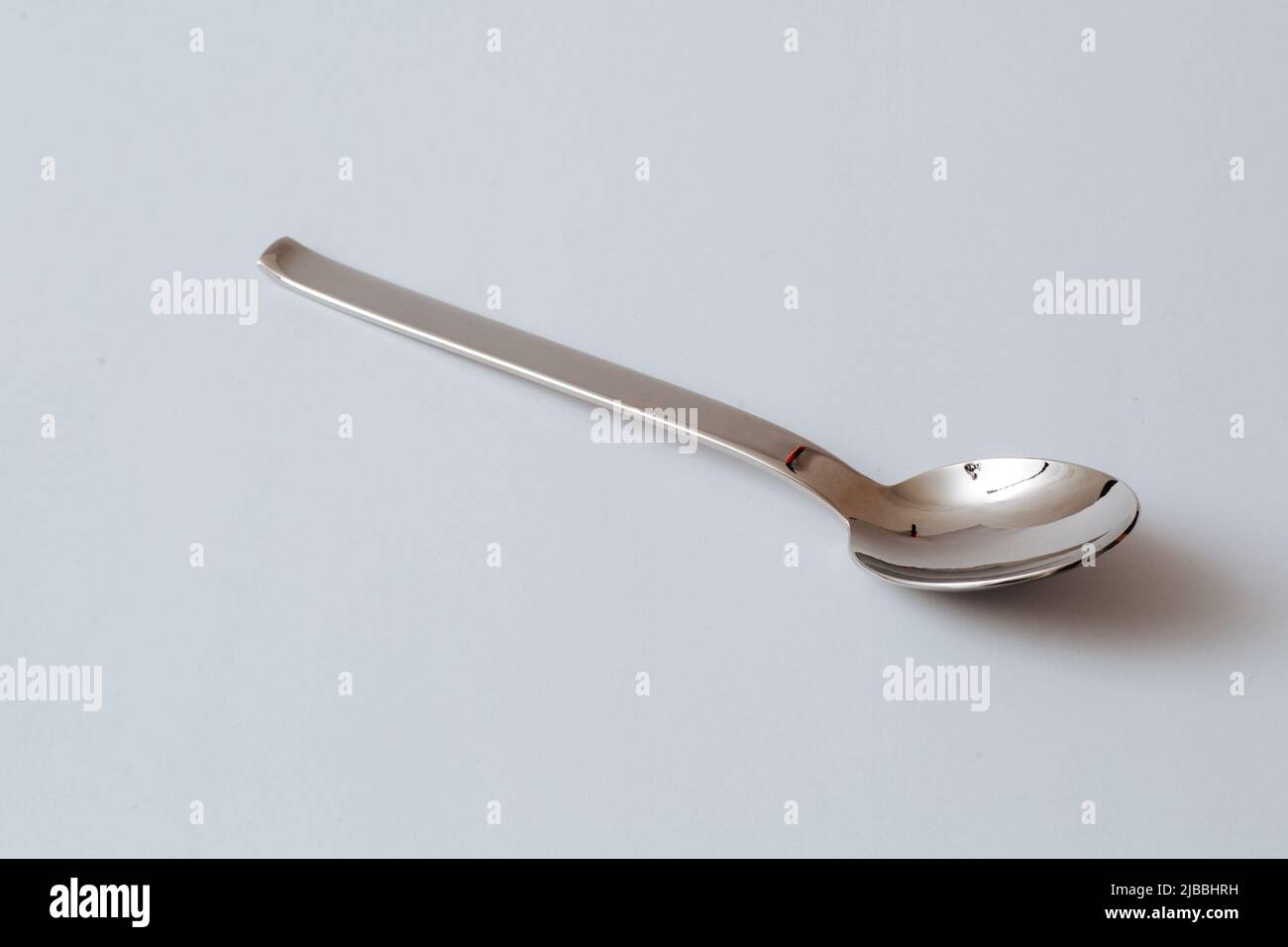 Stainless steel table spoon on white background, copy space Stock Photo ...