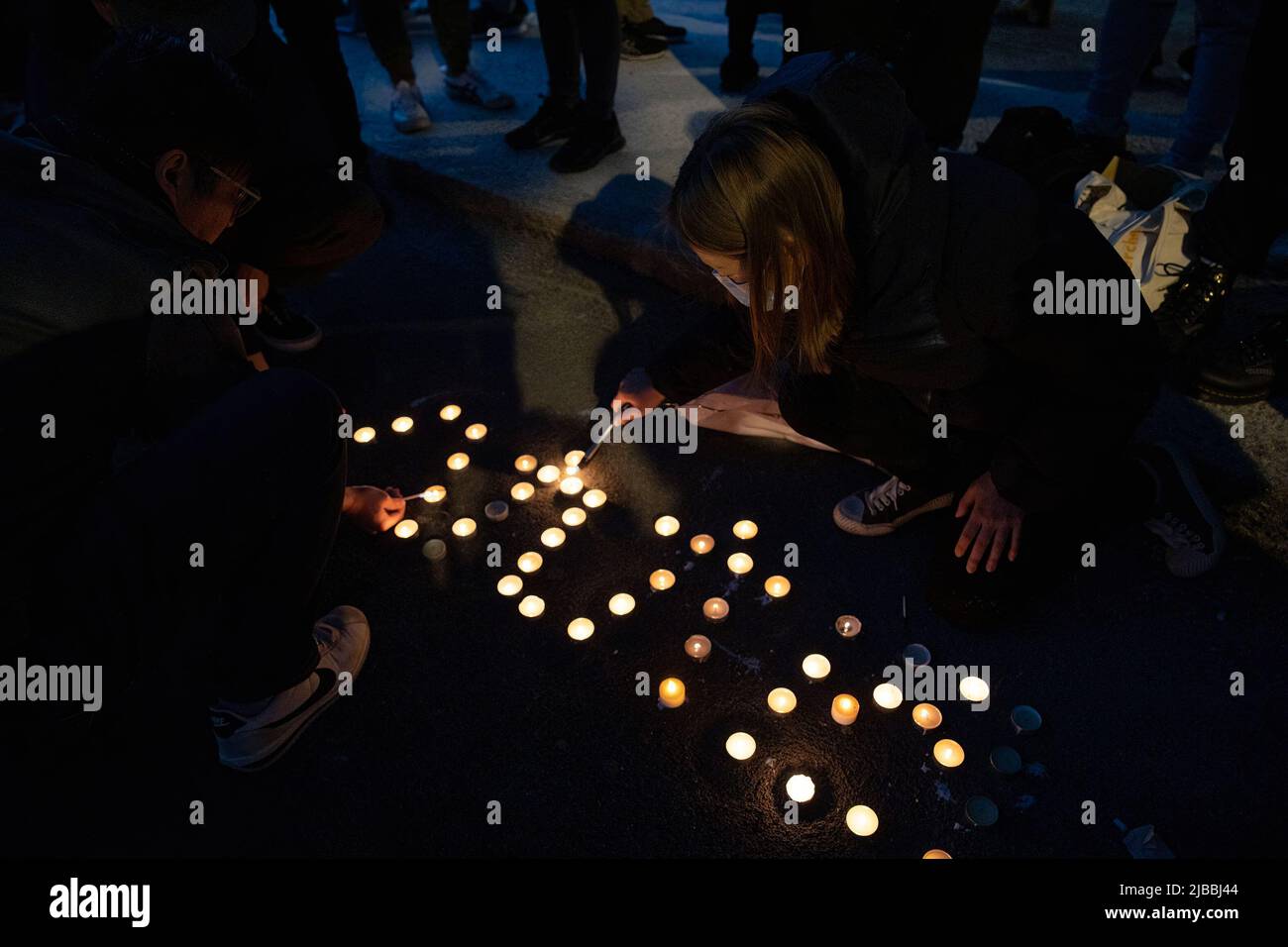 Protesters arrange lit candles as "8964" in Chinese writing during the ...