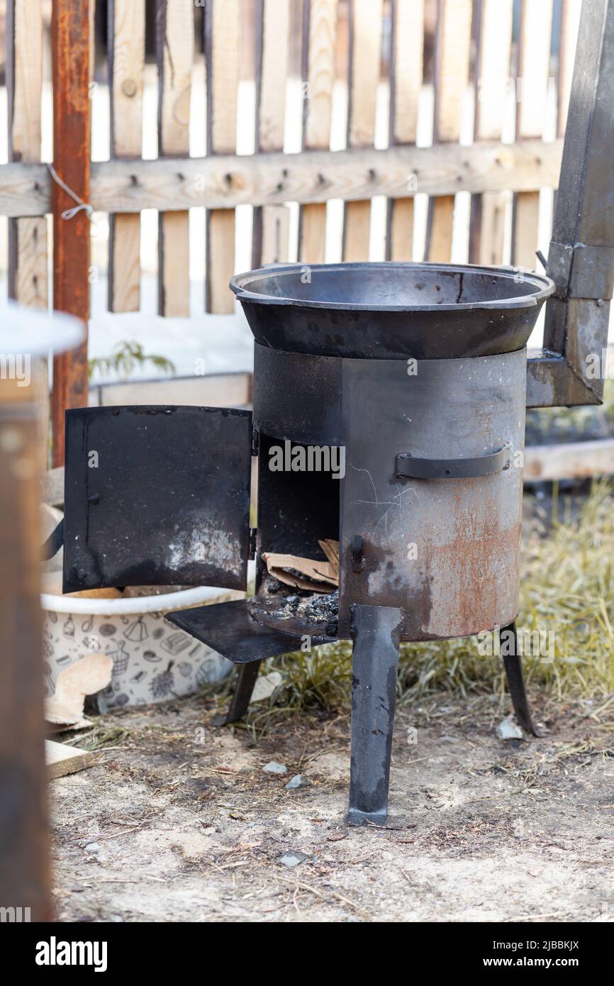 Cooking food or pilaf in a cauldron on fire. Cooking in cauldron on ...