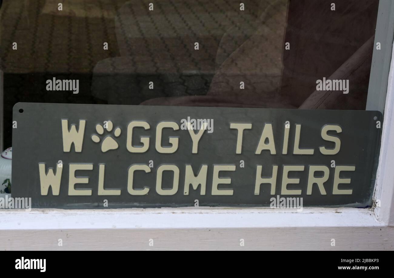 waggy tails welcome here sign in cafe window Stock Photo - Alamy
