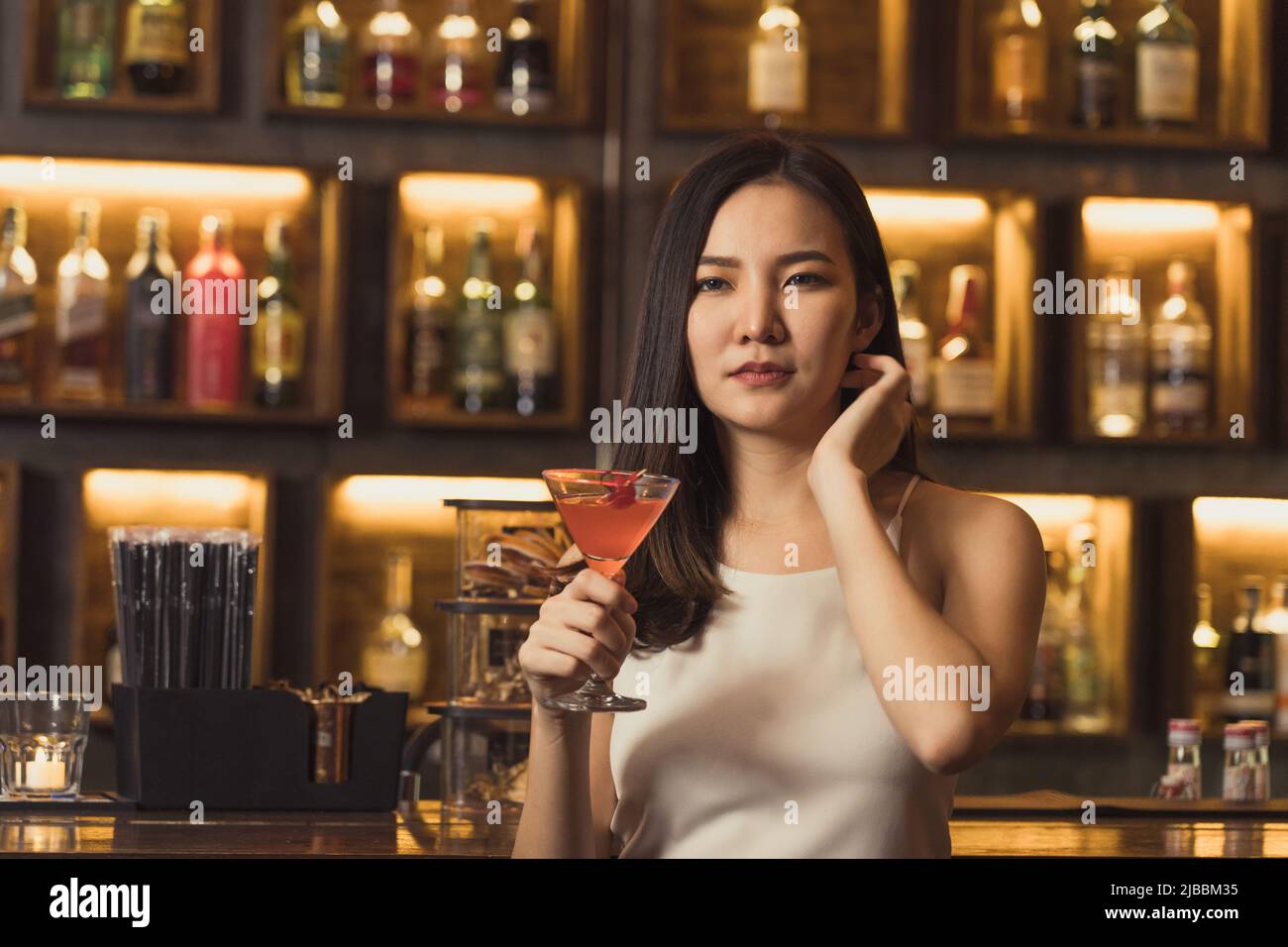 Asian women drinking cocktails and having fun at the bar at night Stock ...