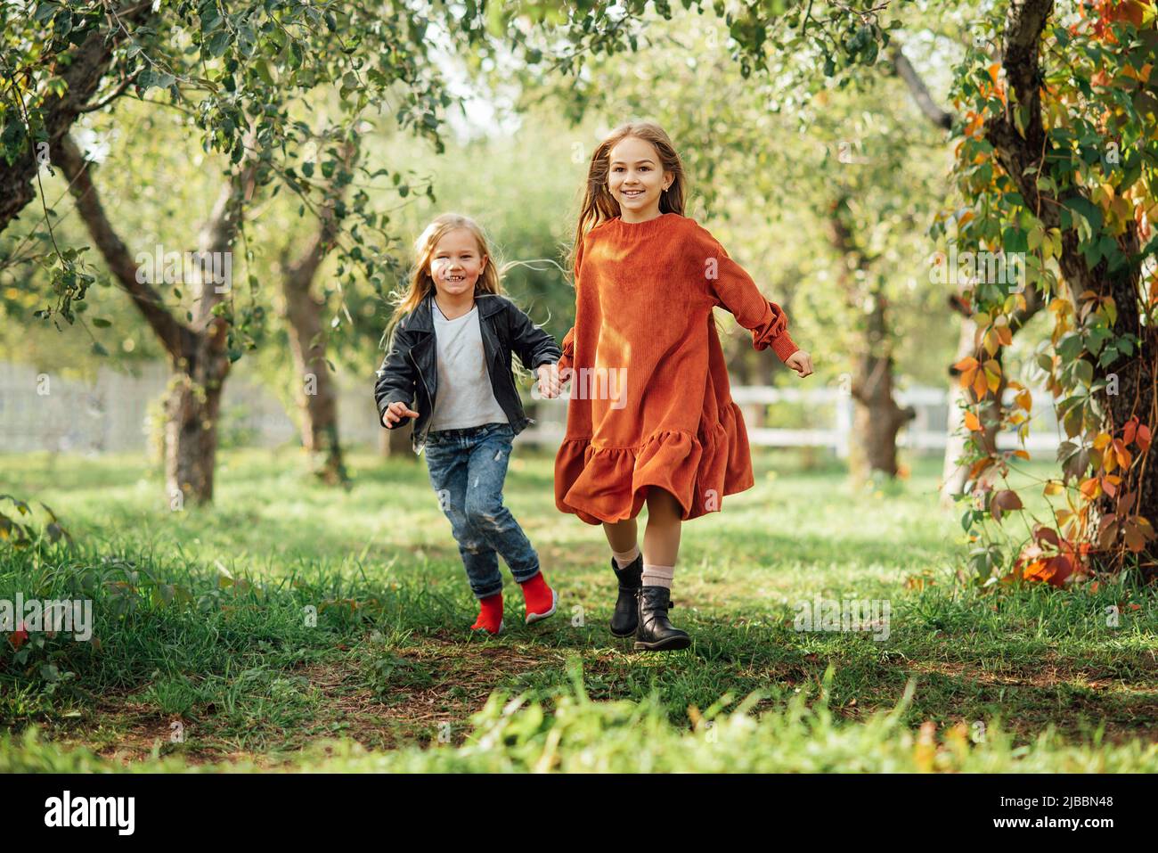 Children running , dancing plays on the meadow. Girls having fun. Cute ...