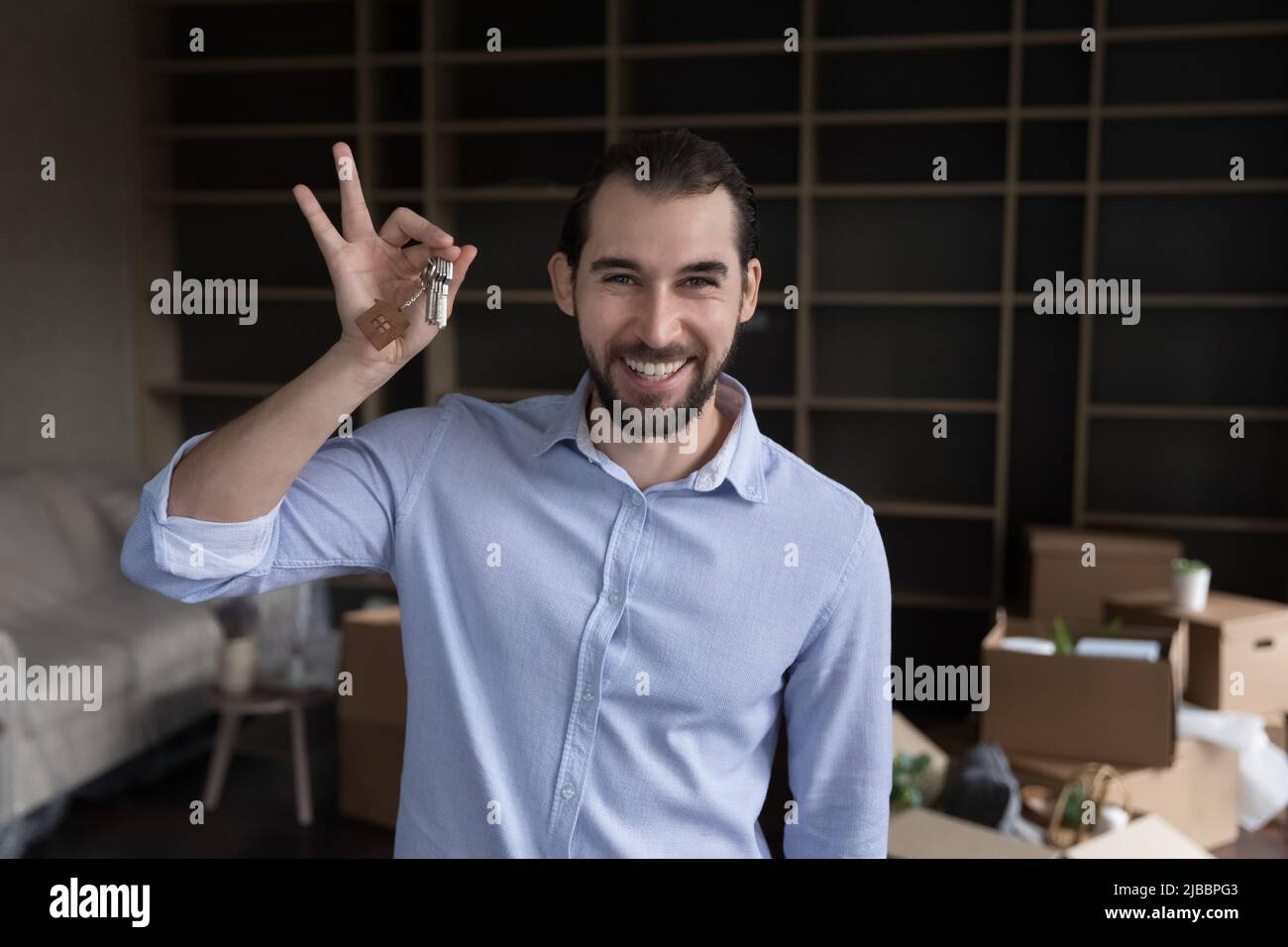 Happy millennial guy showing bunch of keys on camera Stock Photo - Alamy