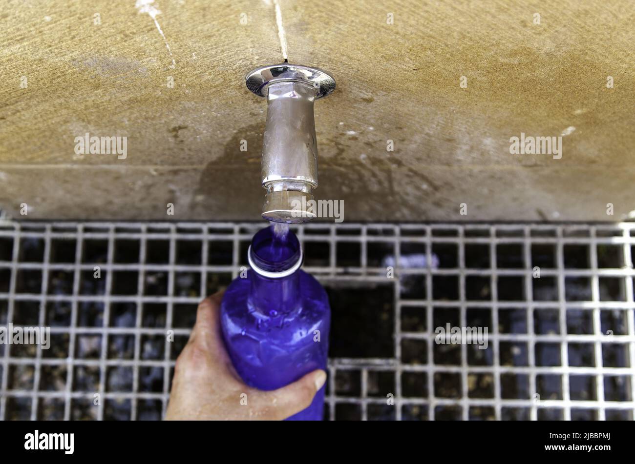 Filling water bottle in fountain, water and summer, refreshment Stock ...