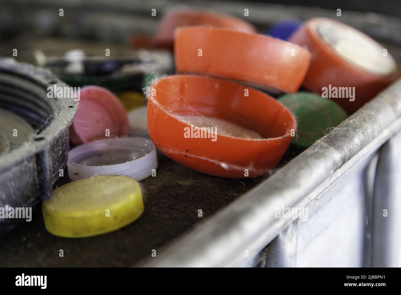 Dirty plastic caps in barrel, recycling and environment Stock Photo - Alamy
