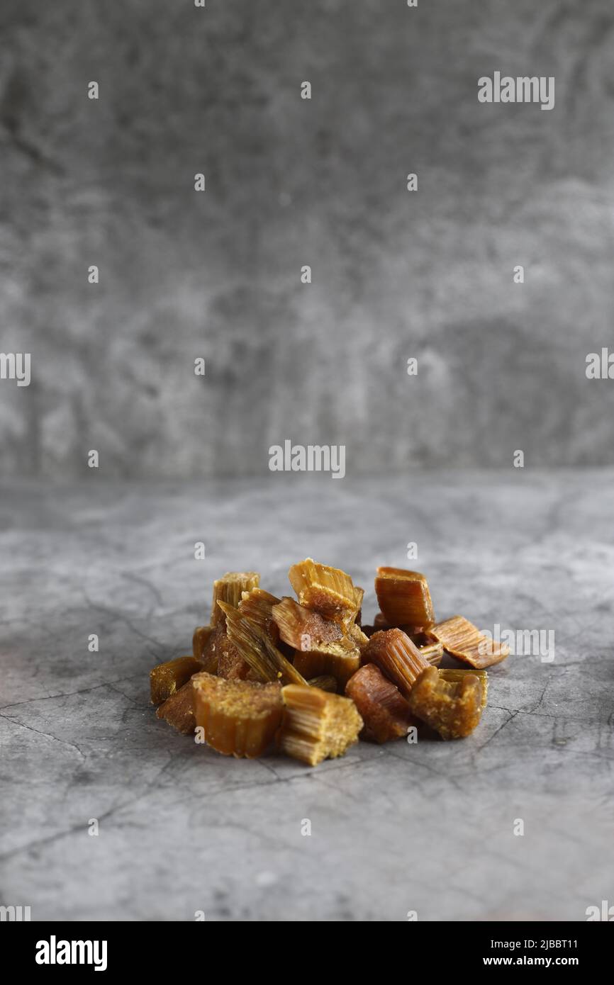 Healthy eating concept - a pile of candied rheum isolated on gray ...