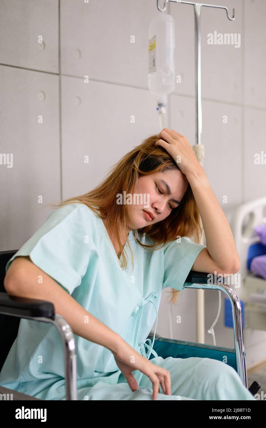 Woman patient on wheelchair with suffering emotional pain stressed ...