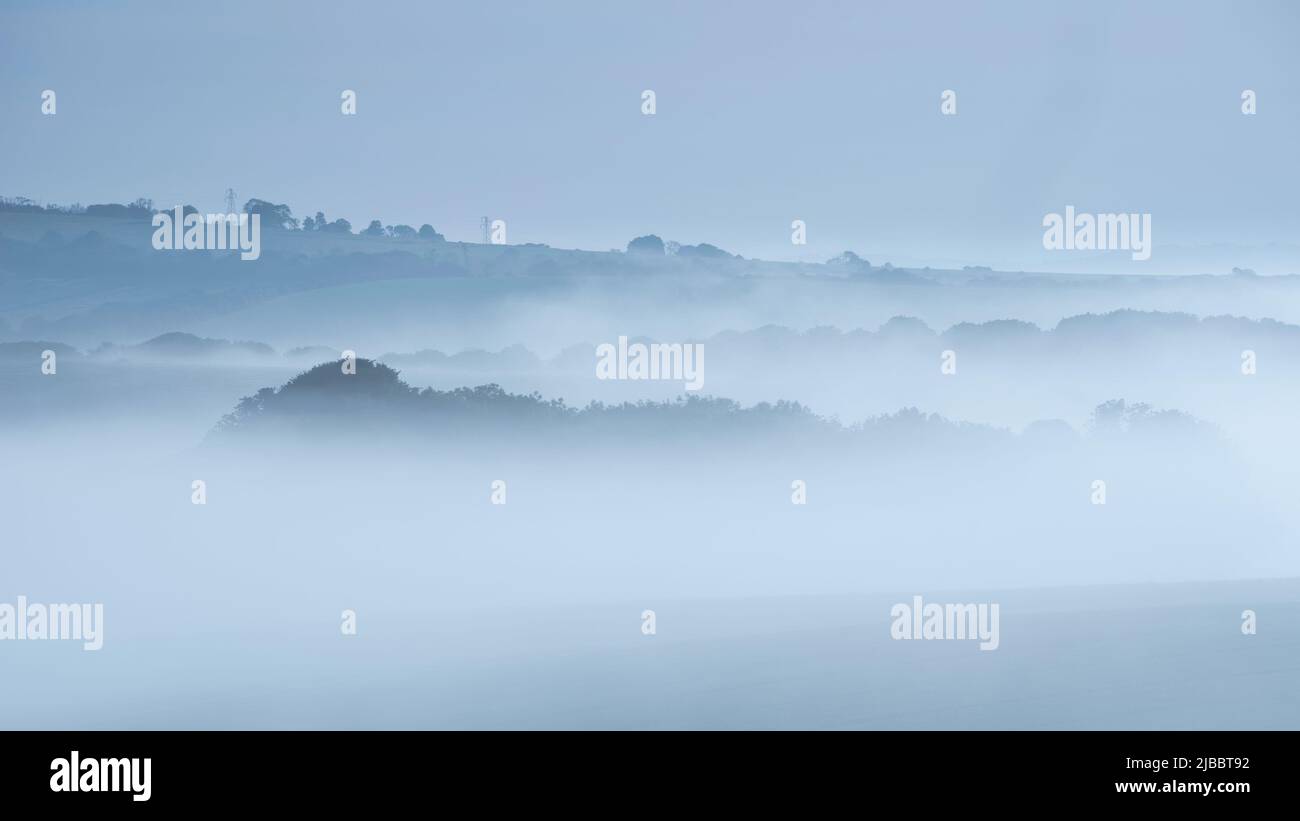 Beautiful landscape image of sea of fog rolling across South Downs ...