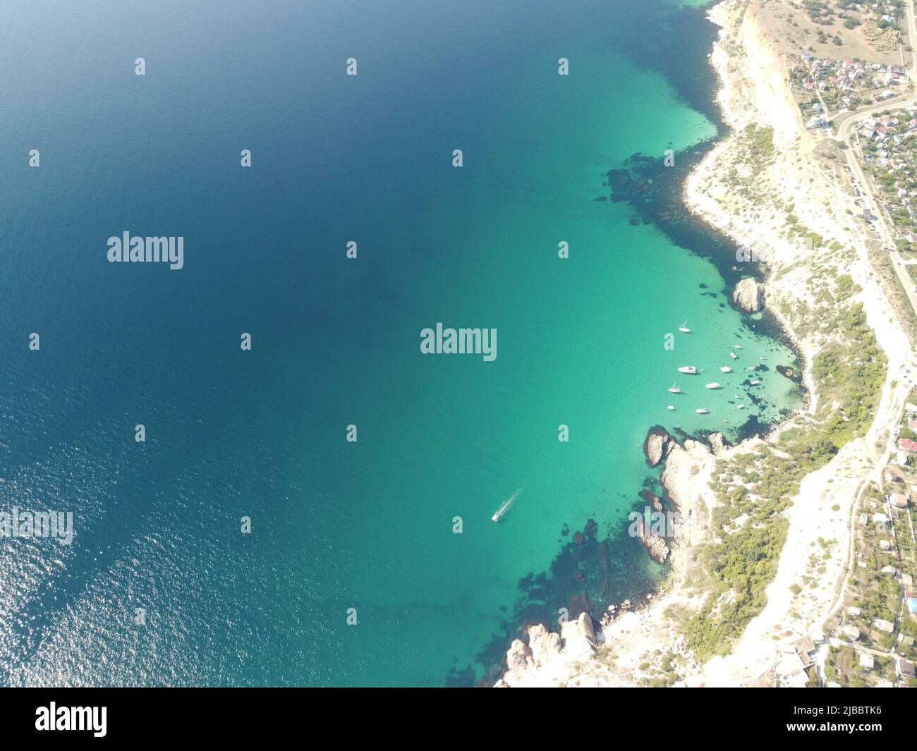 Aerial view from above on calm azure sea and volcanic rocky shores ...