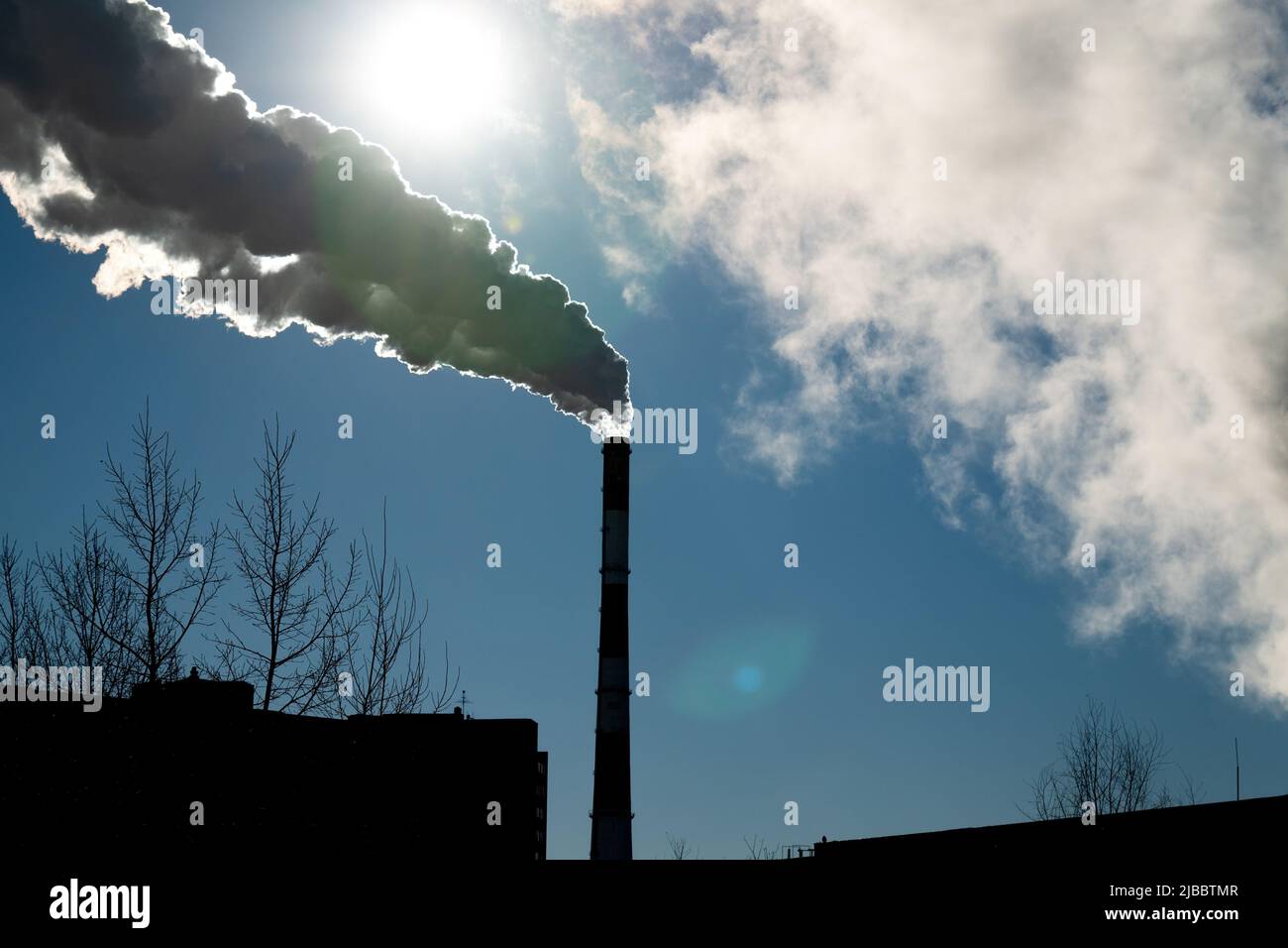 Smoke coming from the pipes of heat and energy plants over winter city ...