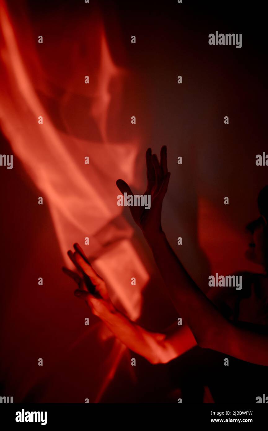 Hands in red light. Abstraction. Shadow theatre, hallucinations Stock ...