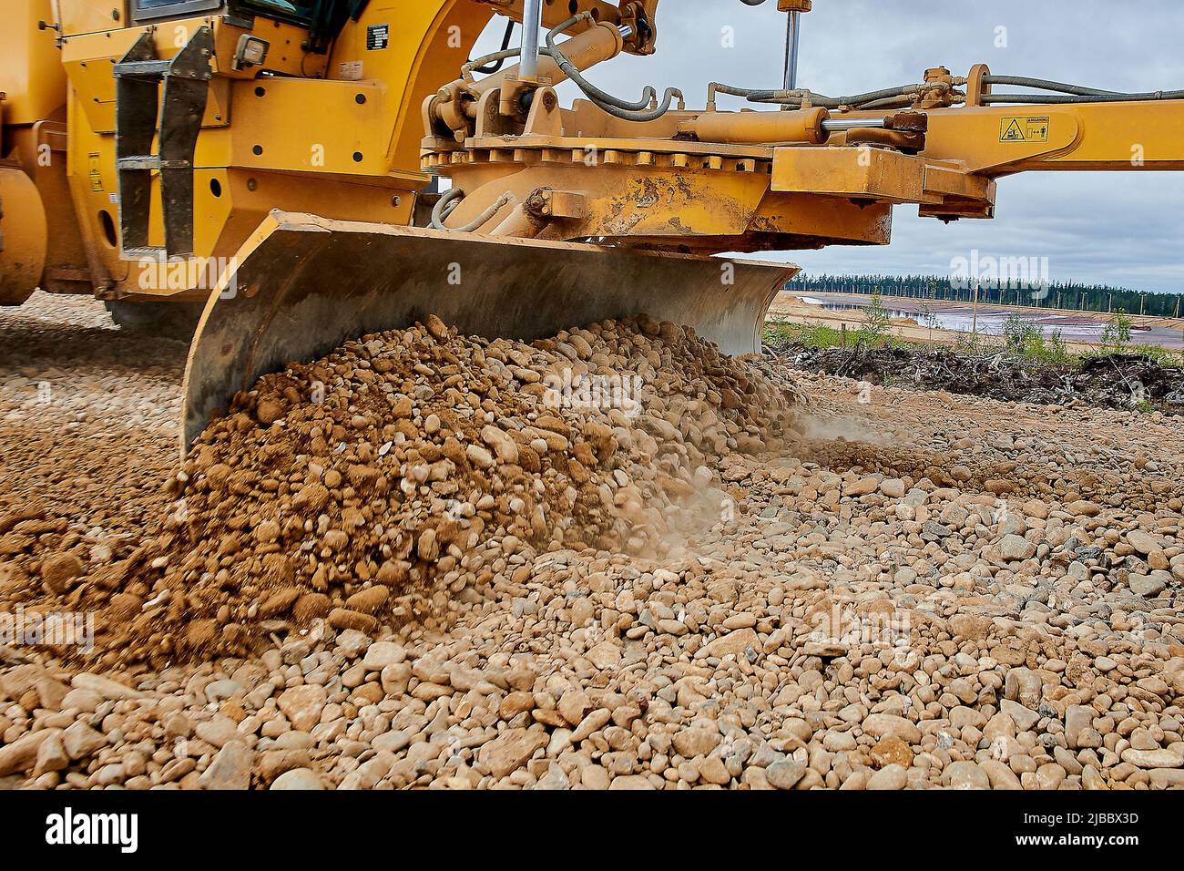 the grader blade levels the rubble at the construction site Stock Photo ...