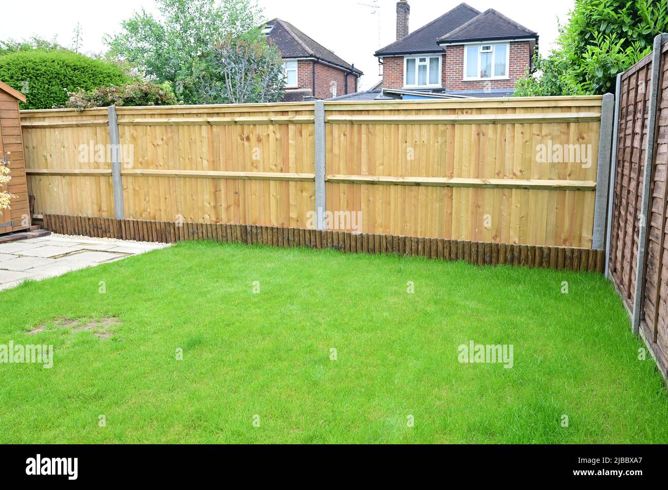 A garden fence in the UK with a small post fence hiding kicker boards ...