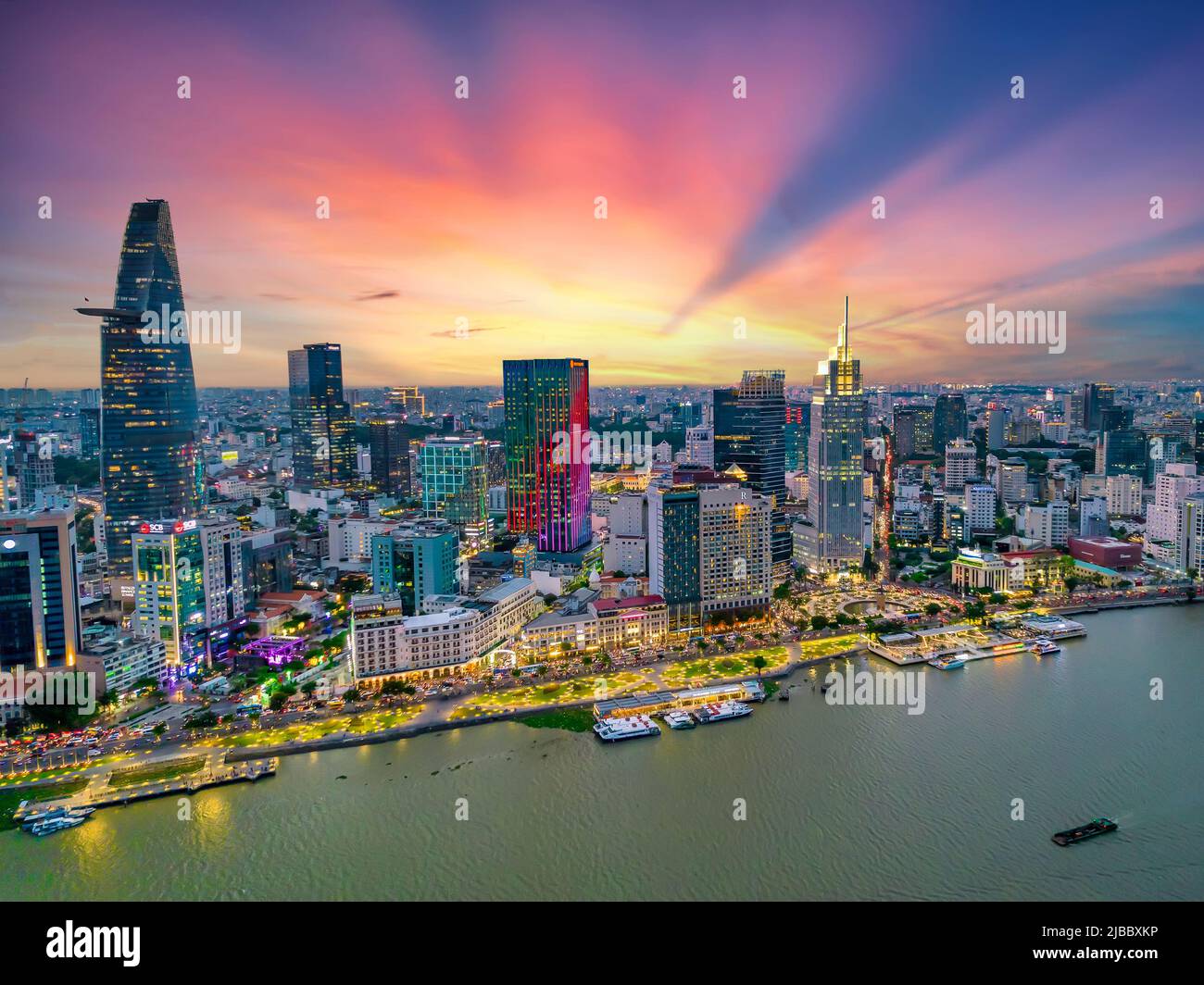 Aerial view of beautiful skyscrapers along the river at sunset sky ...