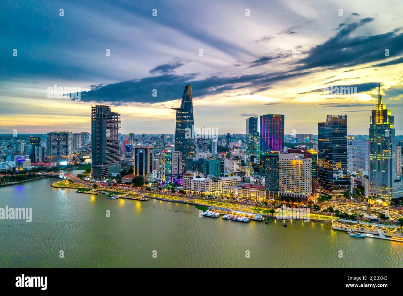 Aerial view of beautiful skyscrapers along the river at sunset sky ...