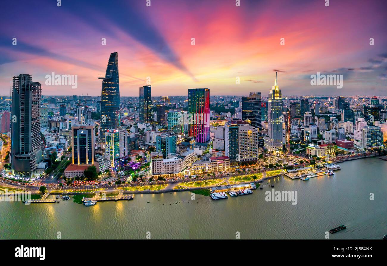 Aerial view of beautiful skyscrapers along the river at sunset sky ...