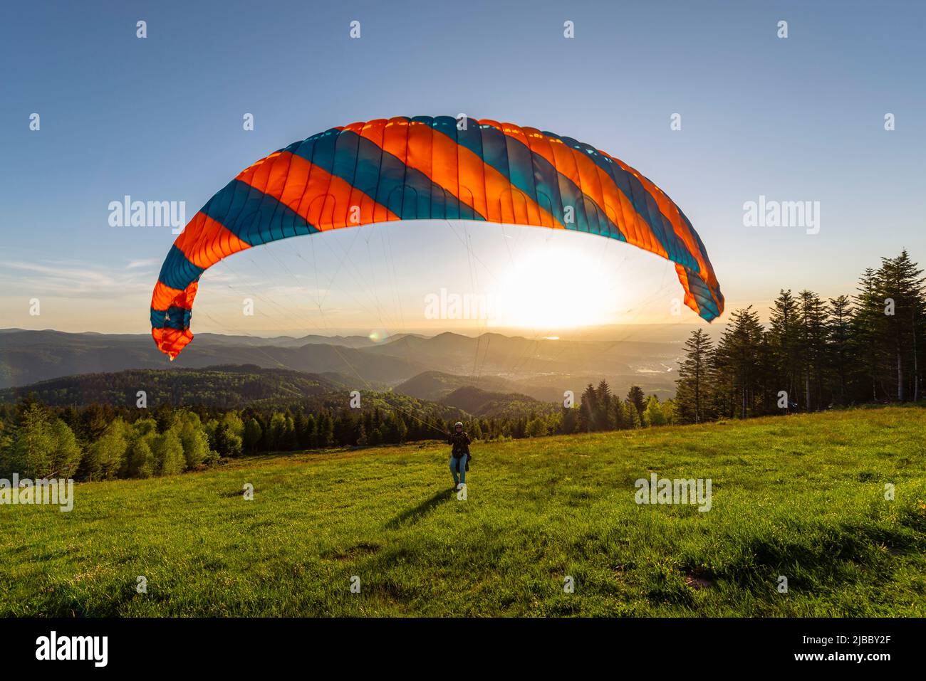 Paraglider at the take-off into the sunset at the Devil's mill launch ...