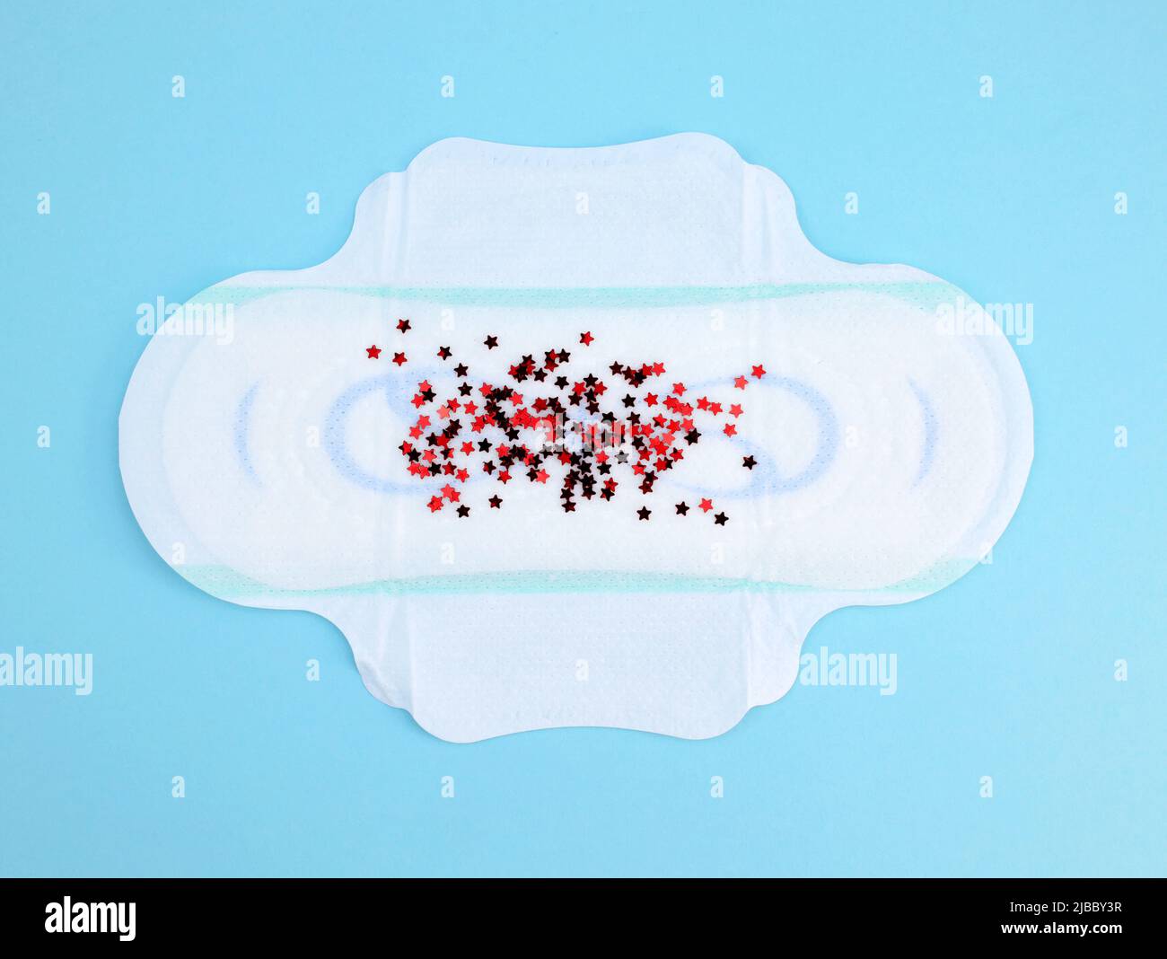 One menstrual pad with red glitter on blue background. Feminine hygiene ...