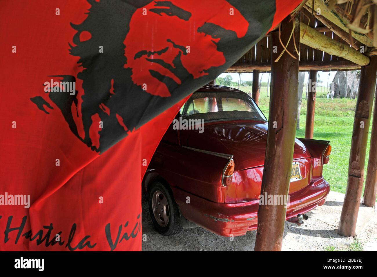 American classic car, covered with a red Che Guevara cloth, Havana ...