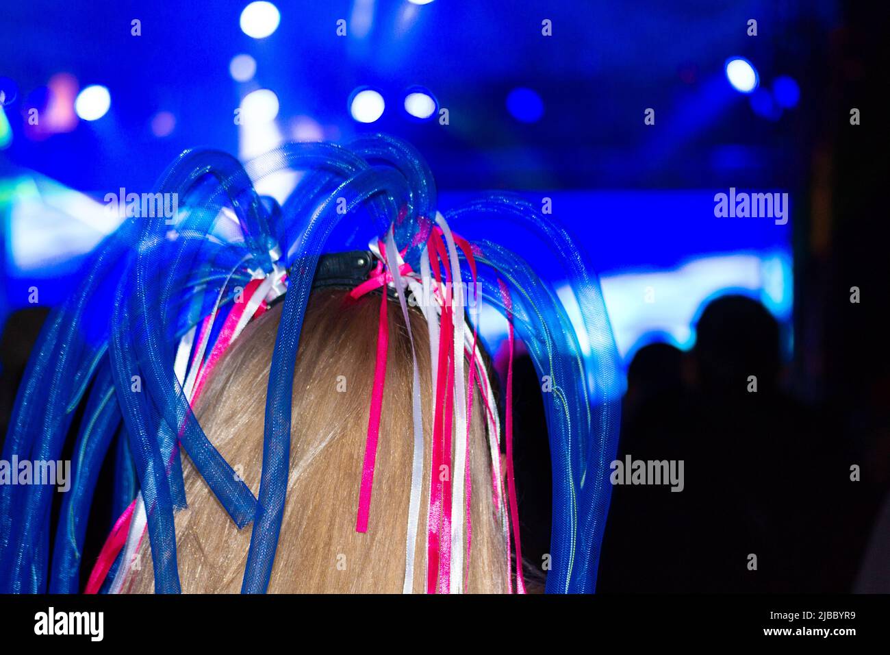 Party headdress accessory on the head of a girl in the audience of live ...
