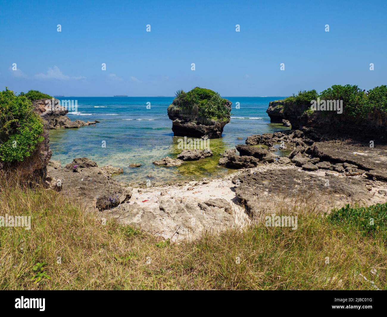 Rocks and hidden sand beaches by the waters of the Indian Ocean at Coco ...