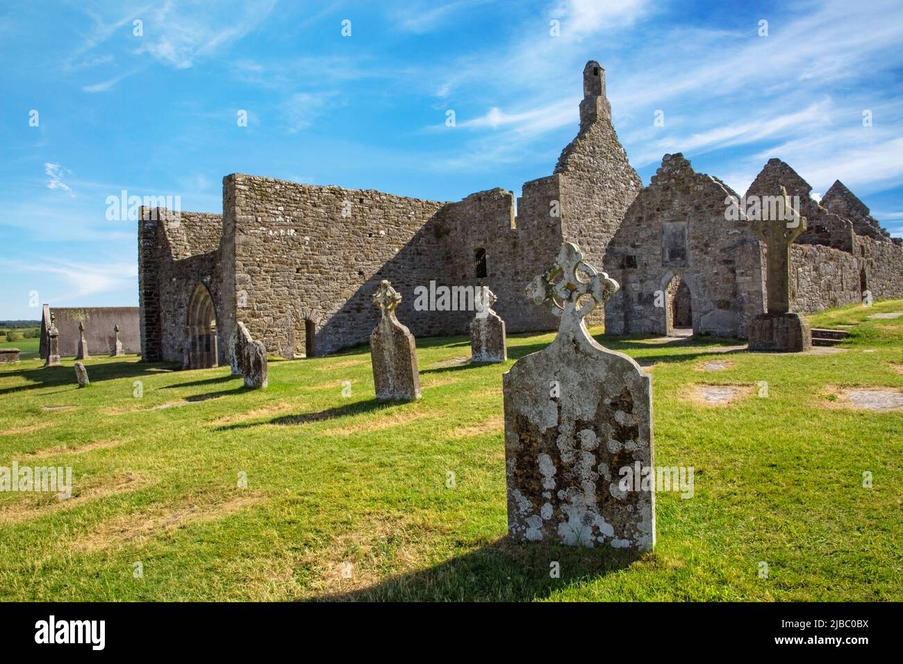 Clonmacnoise Cathedral with the typical crosses and graves. The ...