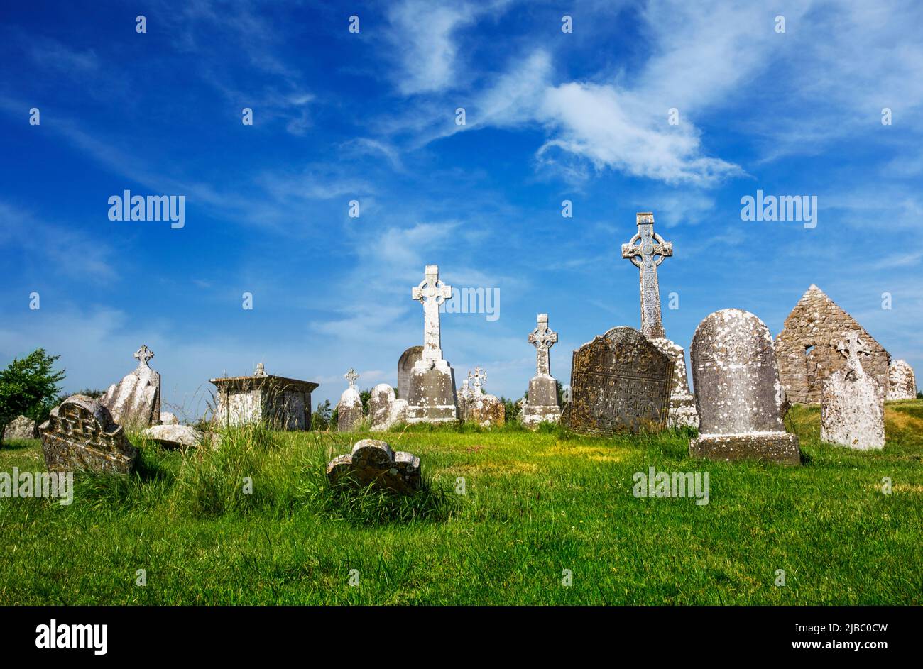 Clonmacnoise Cathedral with the typical crosses and graves. The ...