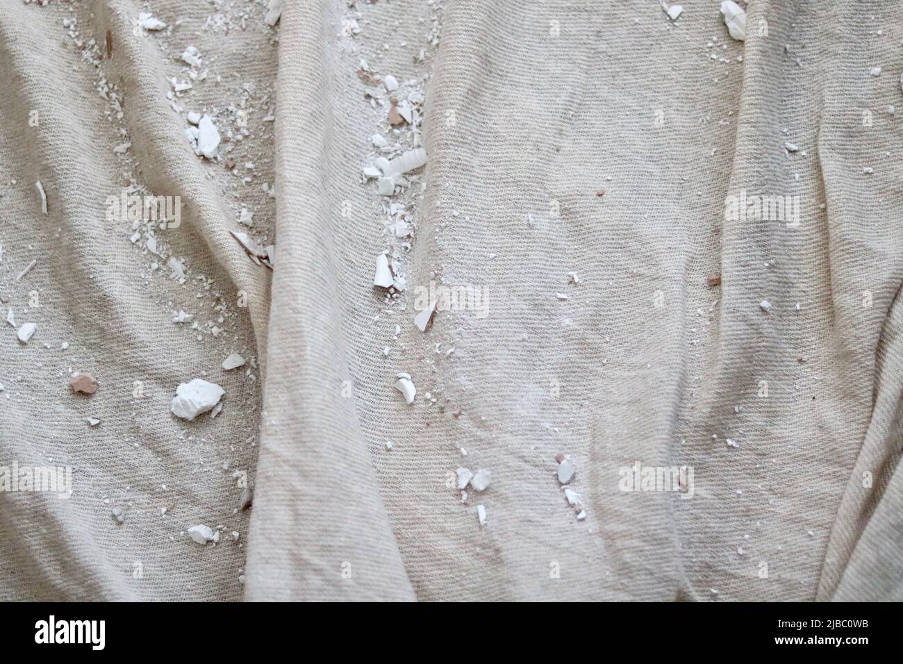 Dirty dust sheet covered with remnants of plaster or detritus Stock ...