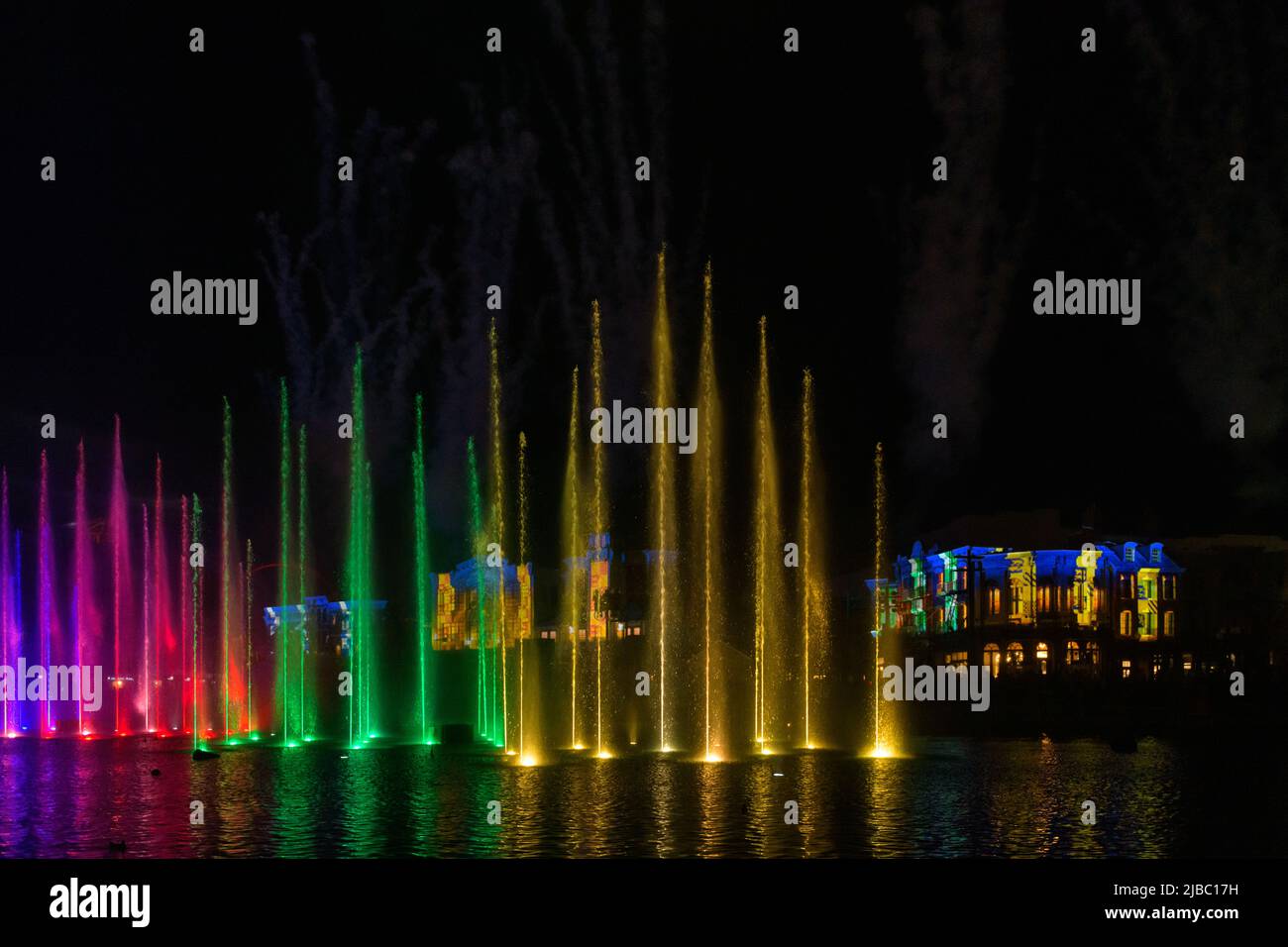 Illuminated fountain during the end of day show. The water is enhanced ...