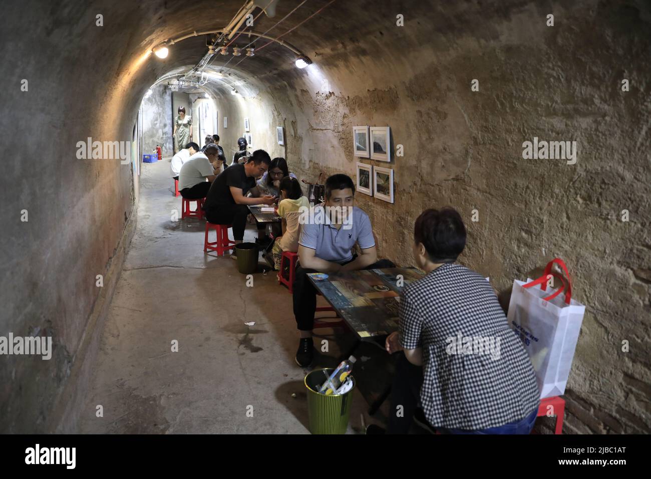 XI'AN, CHINA - JUNE 5, 2022 - People eat food and cool off at a noodle ...