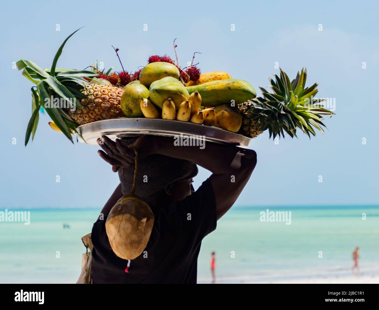 Paje, Zanzibar, Tanzania - January 202: African with a tray full of ...