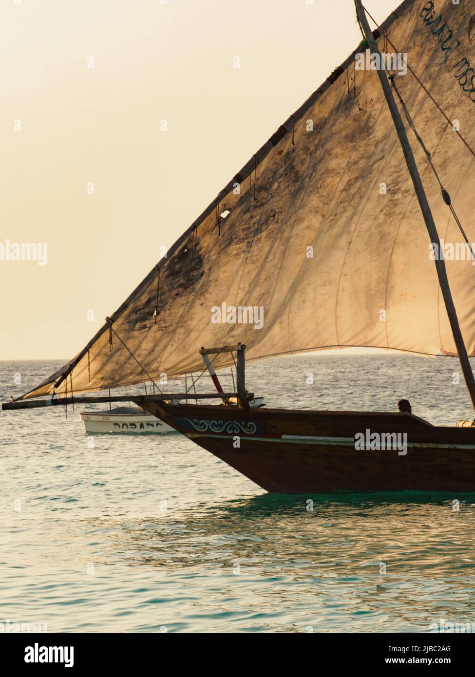 Traditional sailing dhow during sunset in the Indian Ocean off the ...
