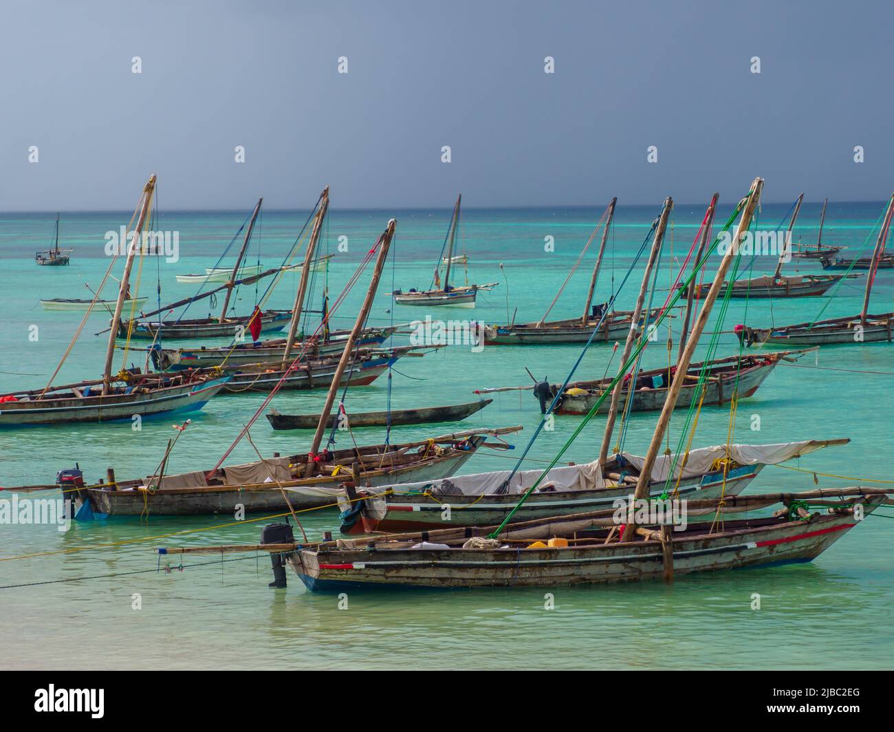 Traditional dhow boats on blue water, Day time. Zanzibar, Tanzania ...