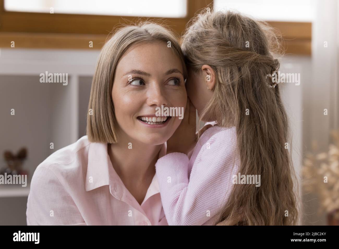 Cute little girl share secrets with young loving mother Stock Photo - Alamy