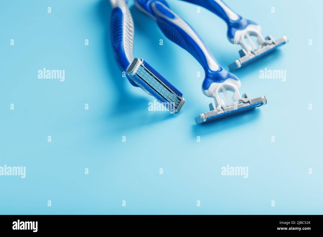 Blue shaving machine with sharp blades on the background of ice cubes ...