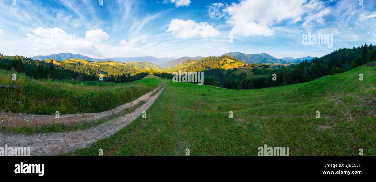 mountainous countryside landscape in the morning. path down the hill in ...