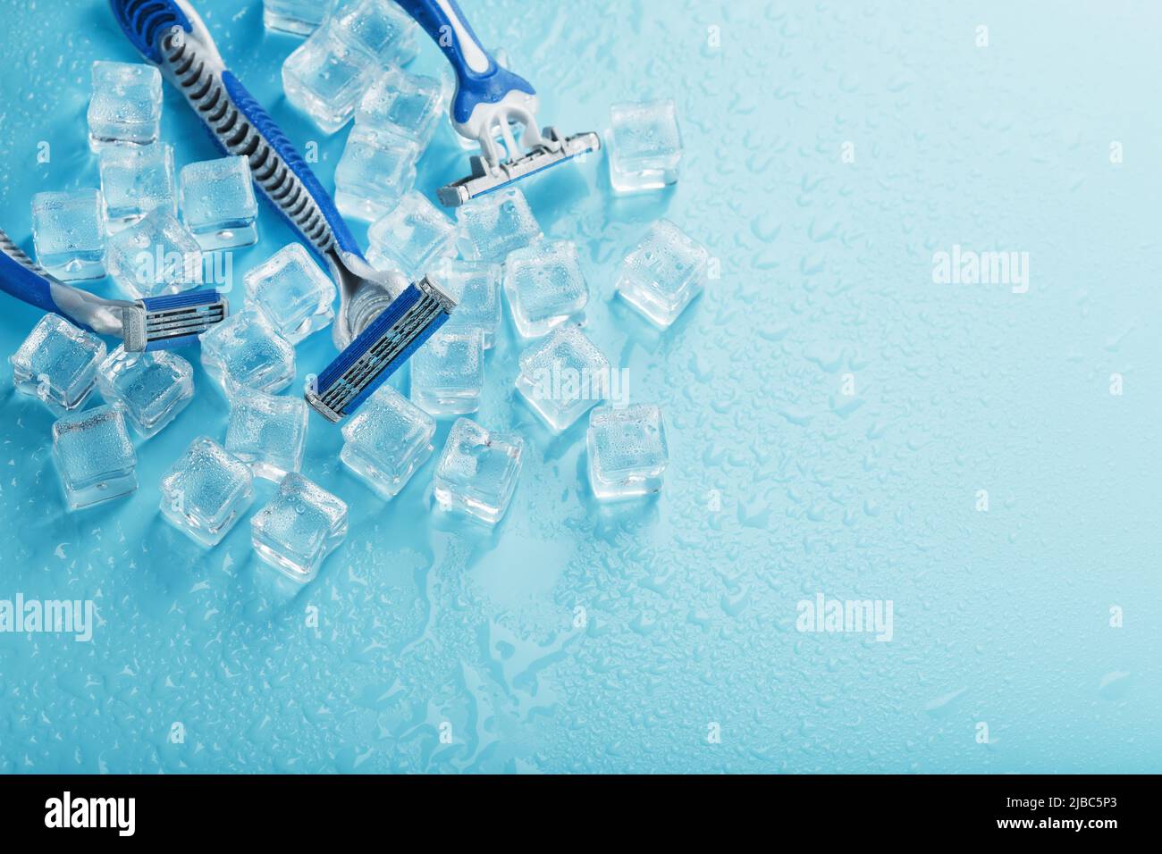 Shaving machine on a blue background with ice cubes. The concept of ...