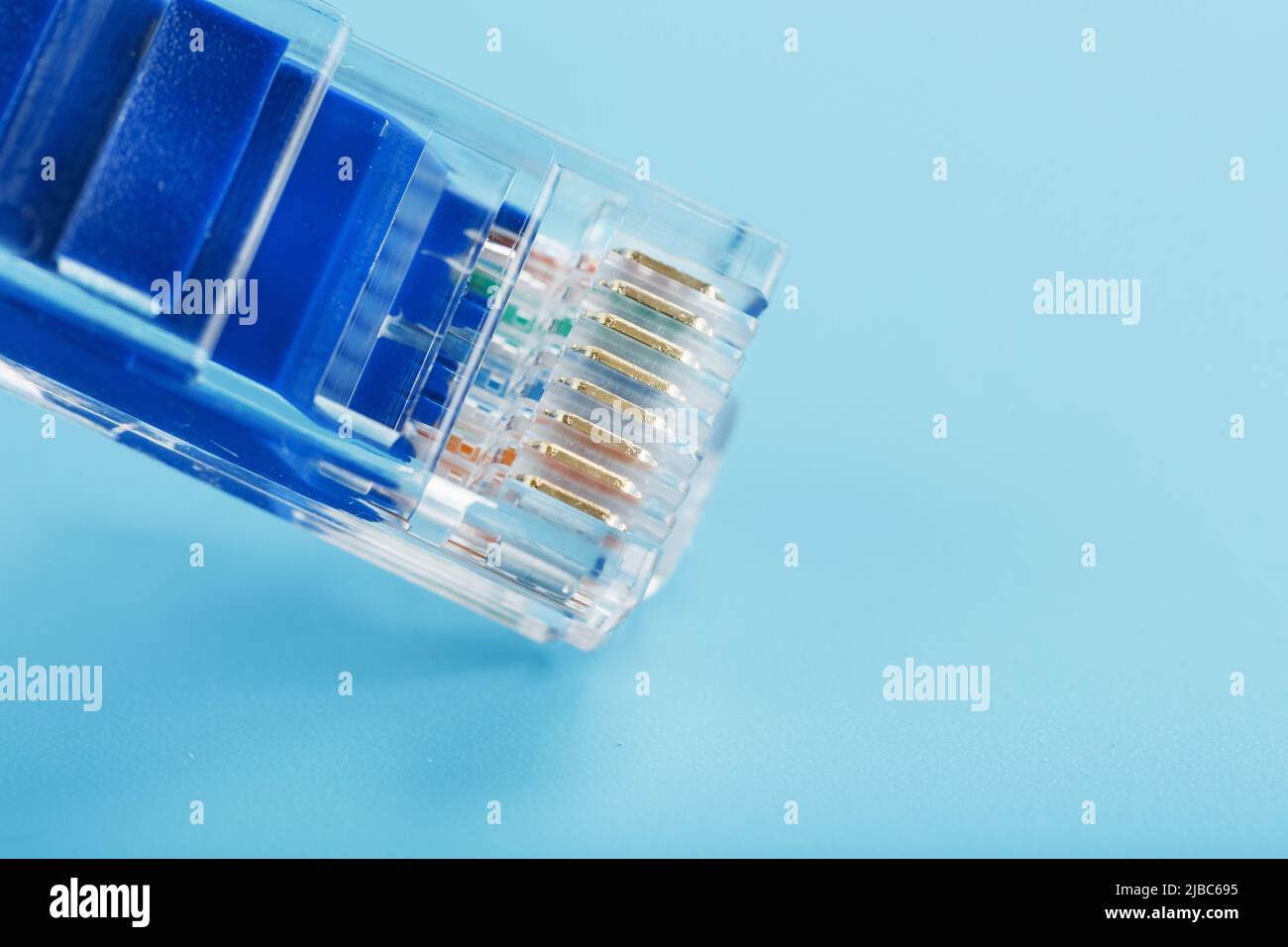 A coil of an Internet network cable for data transmission on a blue ...