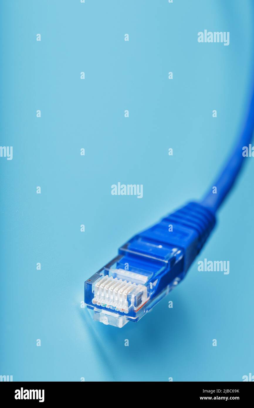 A coil of an Internet network cable for data transmission on a blue ...