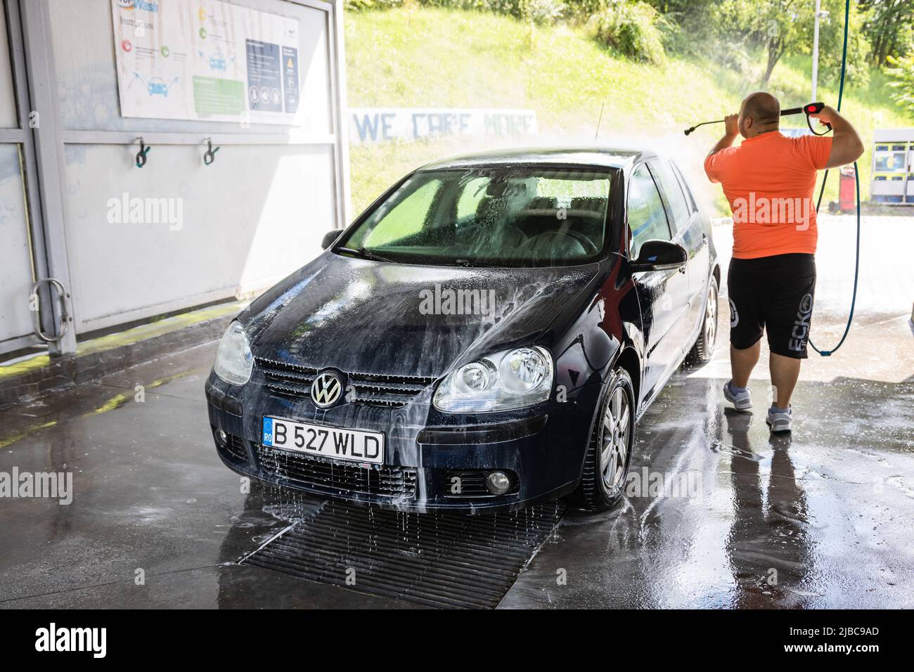Washing and cleaning car in self service car wash station. Car washing ...