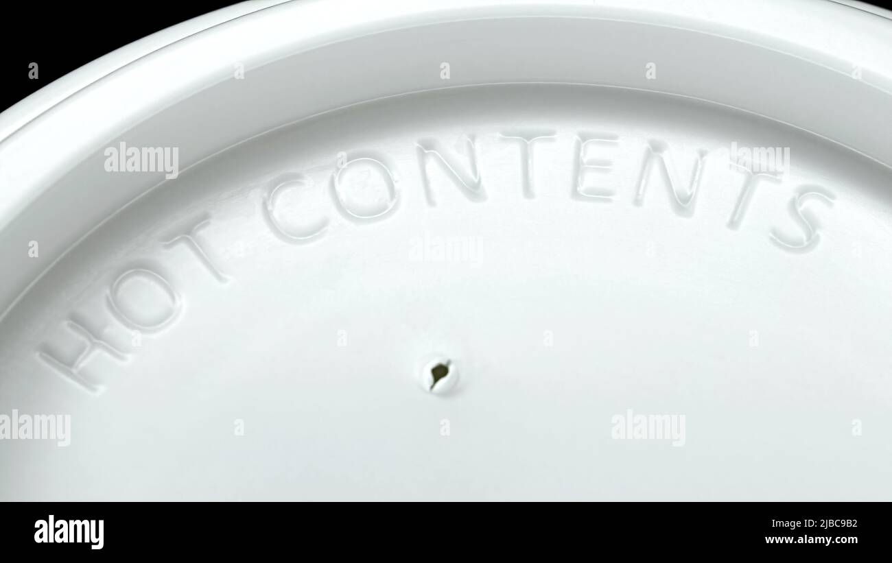 Disposable paper cup with white plastic lid, embossed "HOT CONTENS ...