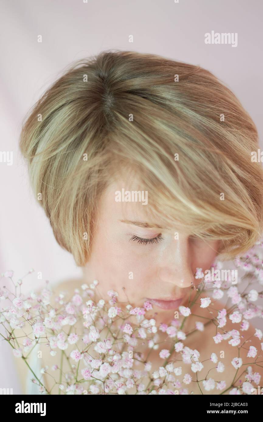 Portrait of a girl on a pink background with flowers. Tenderness and ...