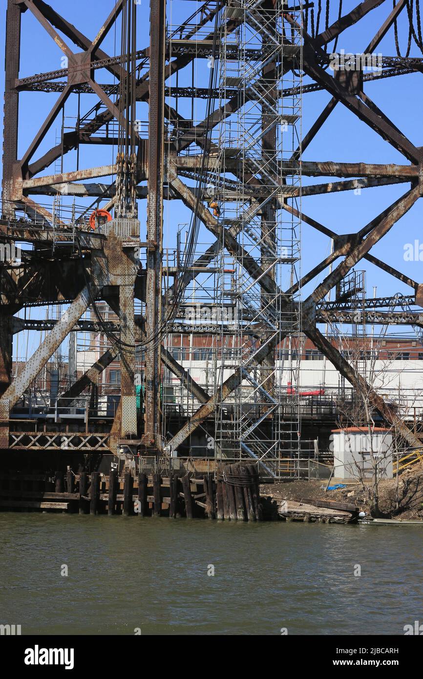 A very tall steel truss structure standing in the industrial district ...