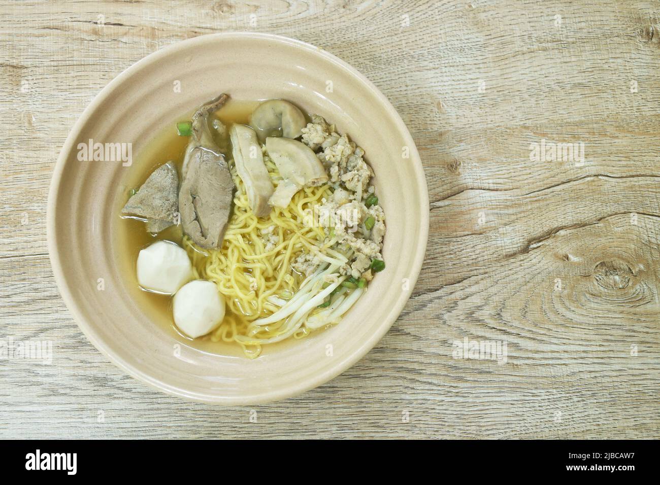 boiled Chinese yellow egg noodles with entrails and fish ball in soup ...