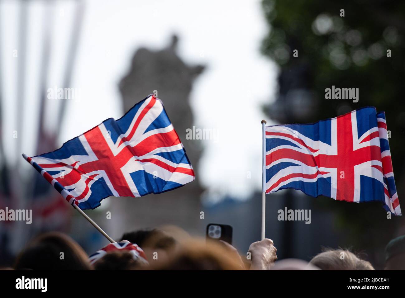 London, UK. 04th June, 2022. Party revelers hold the British Flags ...