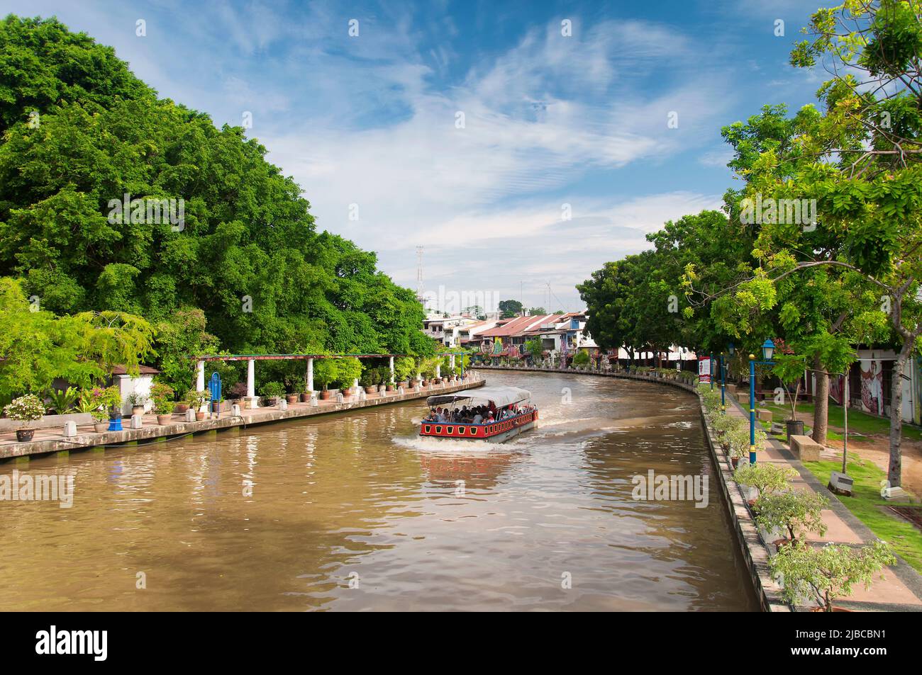 A tourist boat traveling down the melaka river on an architectural tour ...