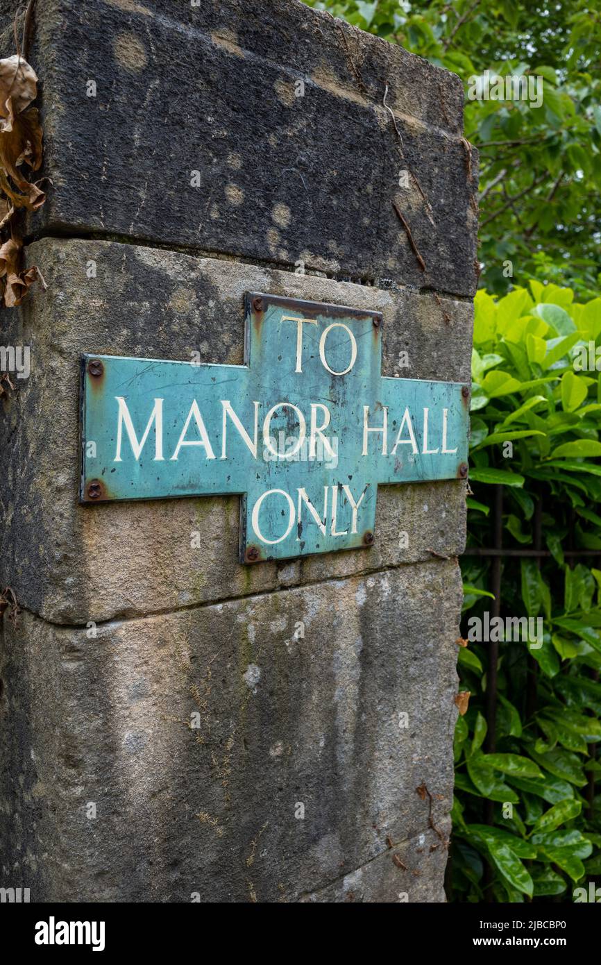 Old weathered sign To the Manor Hall Only (Jun22 Stock Photo - Alamy