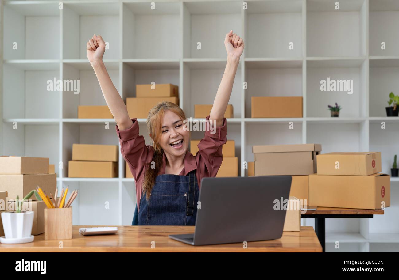 Happy young Asian woman entrepreneur, Smile for sales success after ...